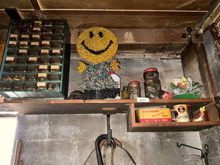 Contents of shelves: parts drawer cabinet, popcorn smiley face, bottles ...