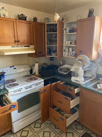 Contents of four cupboards and on top, and four drawers, and corner of ...