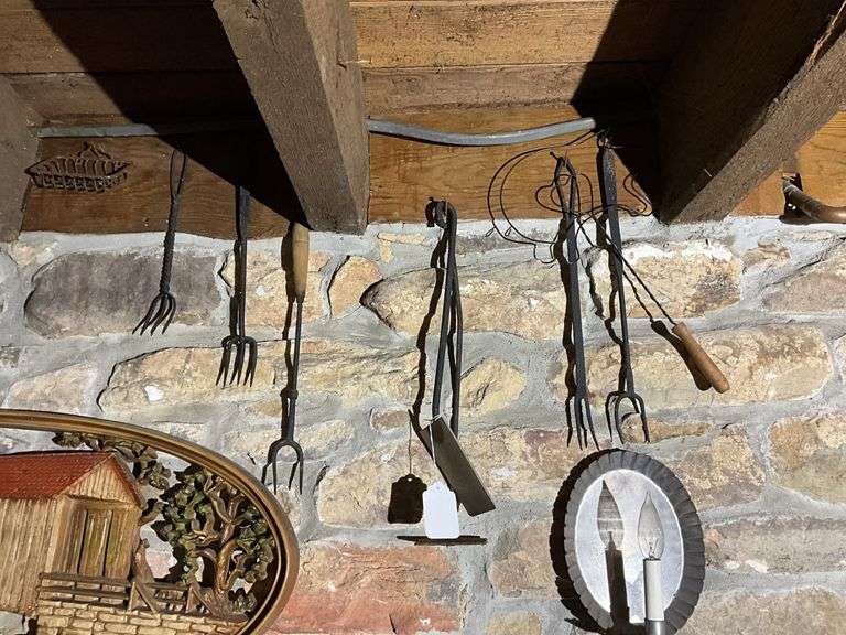 Wrought iron utensils hanging on wall, wire soap dish and pig carpet ...