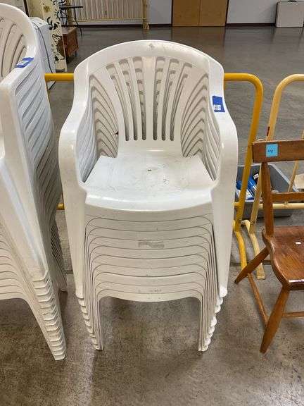 Stack of 10 plastic lawn chairs - Hurley Real Estate & Auctions