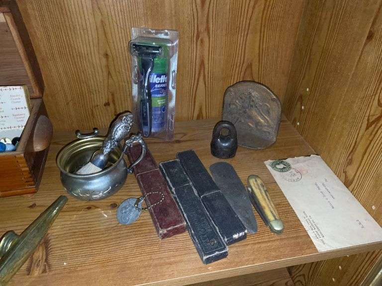 Contents of two shelves: Pocket knife, Yesterdays Child figurines, half ...