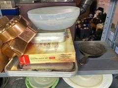 Contents of metal shelving including Tupperware, cast iron skillet ...