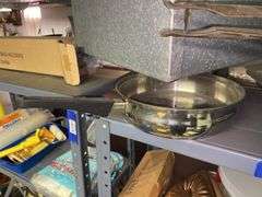 Contents of metal shelving including Tupperware, cast iron skillet ...