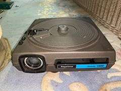 Contents of two shelves: family Bibles, 1952 Life, Keystone slide ...