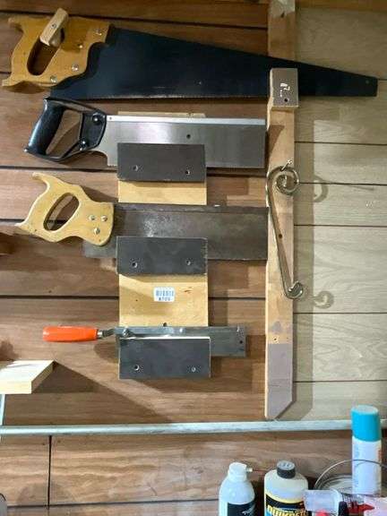 Four hand saws on wall - Hurley Real Estate & Auctions