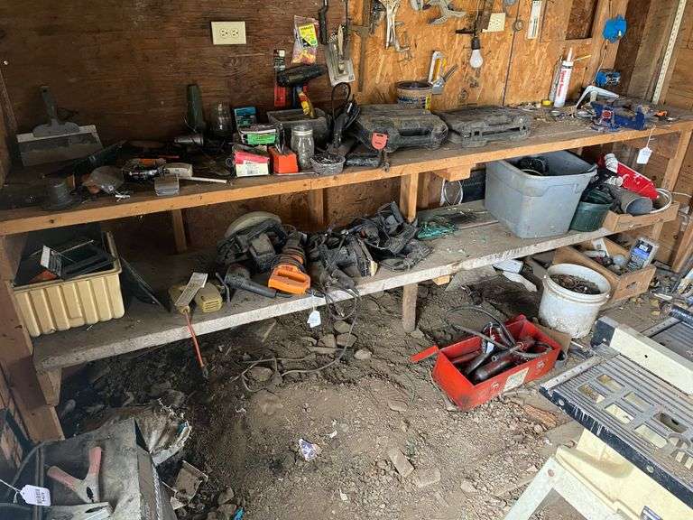 Contents of middle and bottom shelves and on floor at right: power ...