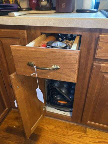 Contents of drawer and cupboard: rolling pin, utensils, baking pans ...
