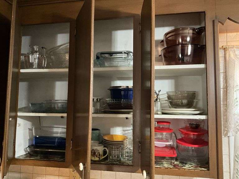 Contents of cupboard: Visions cookware, Pyrex storage, measuring cups ...