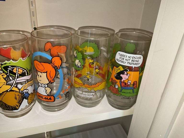 Contents of shelf: decorated glasses including Mickey Mouse ...