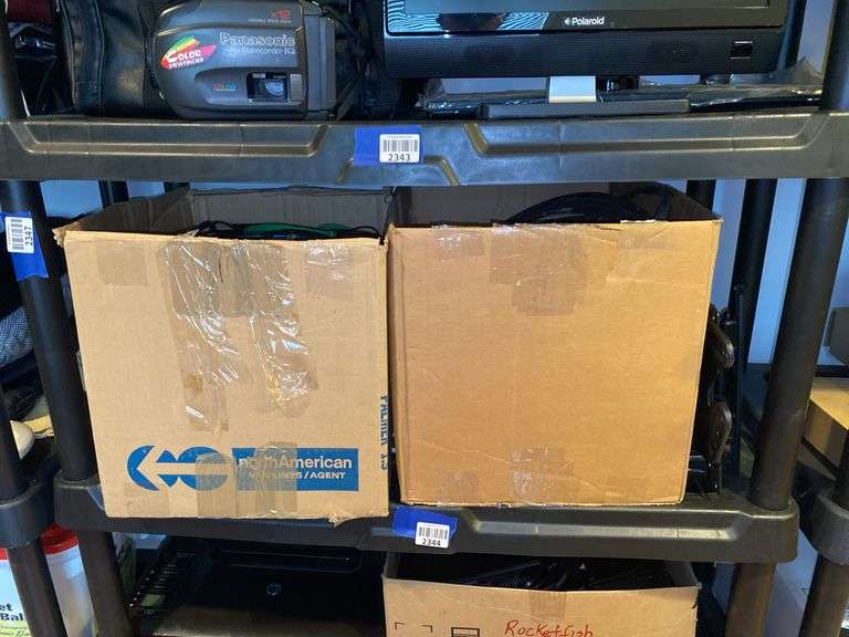 Contents of shelf: electronic cables, power strip, extension cords ...