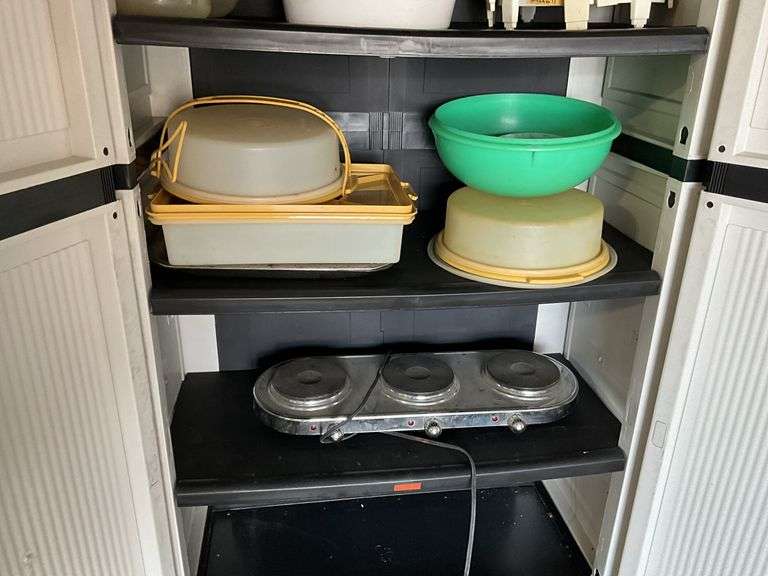 Contents of cupboard: triple hotplate, Tupperware, tins, plasticware ...