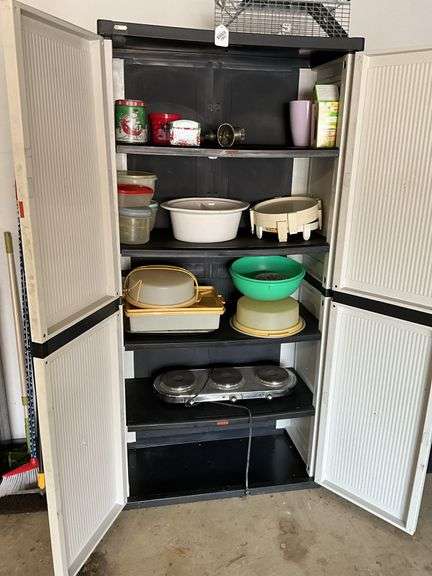 Contents of cupboard: triple hotplate, Tupperware, tins, plasticware ...