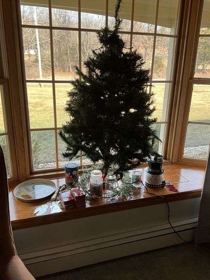 Contents of bay window: Christmas tree, snowman jar, candles, ornaments ...