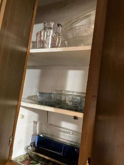 Contents of cupboard: Visions cookware, Pyrex storage, measuring cups ...