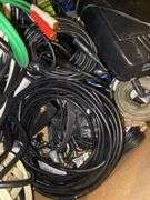 Contents of shelf: electronic cables, power strip, extension cords ...