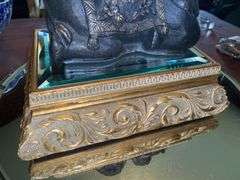 Elephant figure carrying crystal ball, on plateau mirror, under glass ...