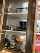 Contents of cupboard: Visions cookware, Pyrex storage, measuring cups ...