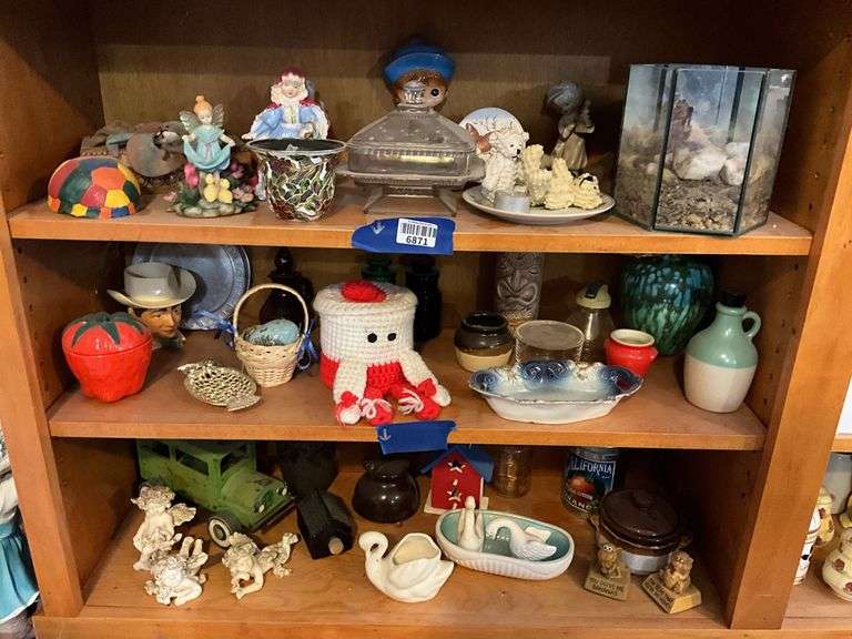Contents of three shelves: vintage Roy Rogers mug, figurines, metal ABC ...