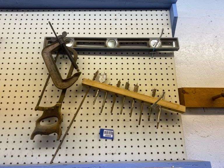 Level, paddle bits, C clamp, hack saw hanging on pegboard - Hurley Real ...