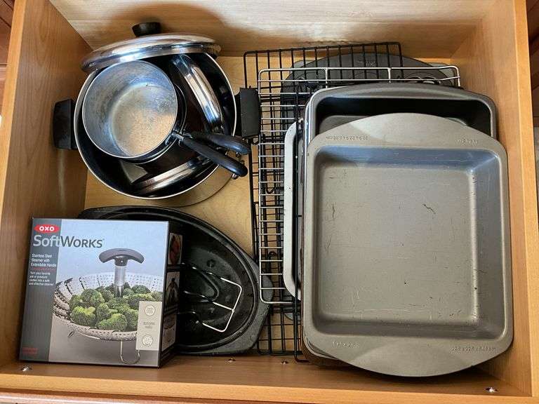 Contents of three drawers: cookware, baking pans, flatware, utensils ...