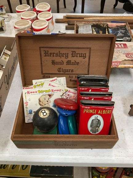 Cigar box and contents: Prince Albert tobacco tins, paper toys, coin ...
