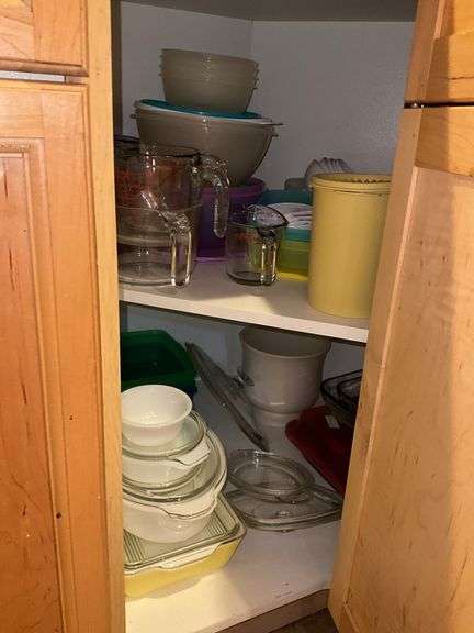 Contents of cupboard: Pyrex, measuring cups, Tupperware, plasticware ...