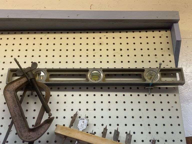 Level, paddle bits, C clamp, hack saw hanging on pegboard - Hurley Real ...