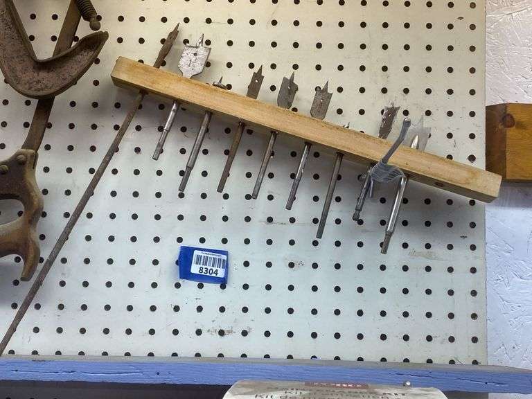 Level, paddle bits, C clamp, hack saw hanging on pegboard - Hurley Real ...