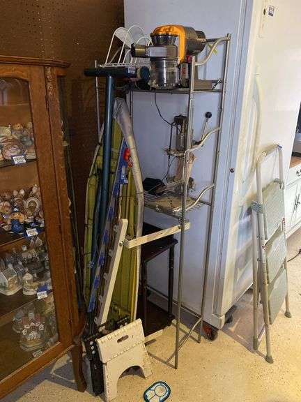 Contents of shelf unit: Dyson hand held vacuum, drill press stand ...