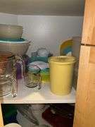 Contents of cupboard: Pyrex, measuring cups, Tupperware, plasticware ...