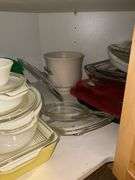 Contents of cupboard: Pyrex, measuring cups, Tupperware, plasticware ...