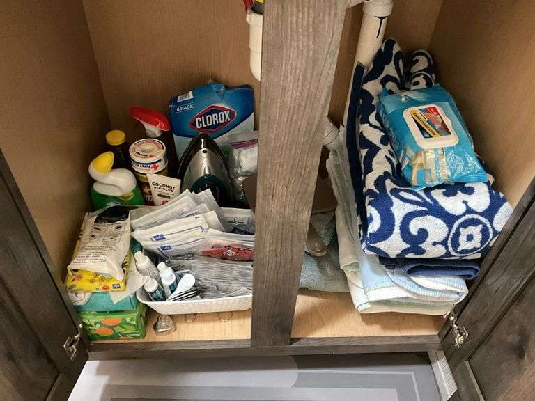 Contents under sink to include towels, iron, cleaners and more ...