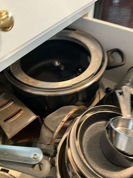 Contents of drawer: cookware, food mill, measuring cups, misc kitchenware - Hurley Real Estate ...