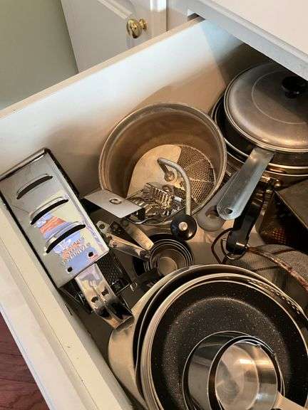 Contents of drawer: cookware, food mill, measuring cups, misc kitchenware - Hurley Real Estate ...