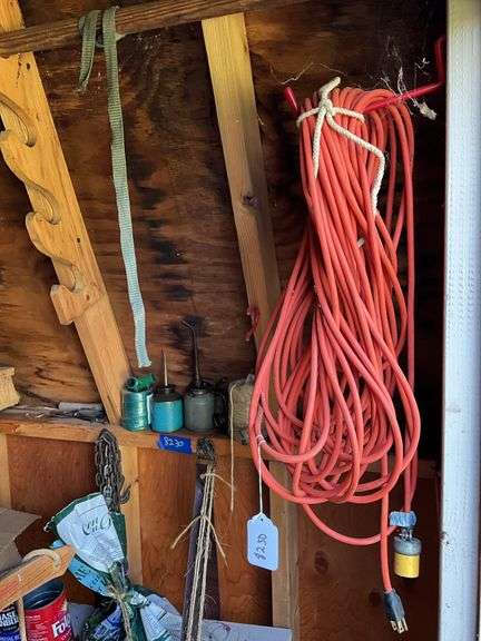 Items on right wall: extension cord, hardware, oil cans, pole pruner ...