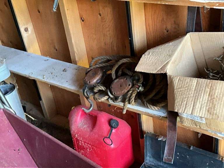 Items on right wall: extension cord, hardware, oil cans, pole pruner ...