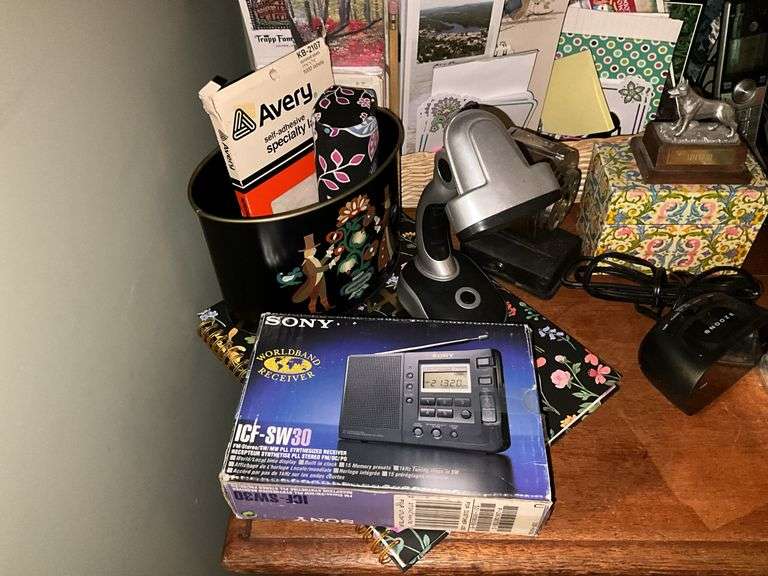 Contents of desk top and underneath: cordless phones, digital camera ...