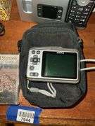 Contents of desk top and underneath: cordless phones, digital camera ...