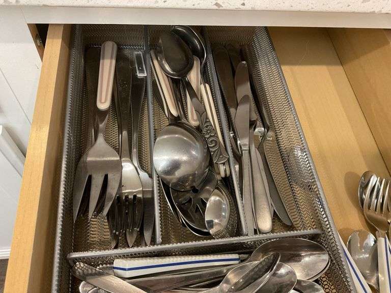 Contents of kitchen drawer - stainless still flatware & serving pieces ...