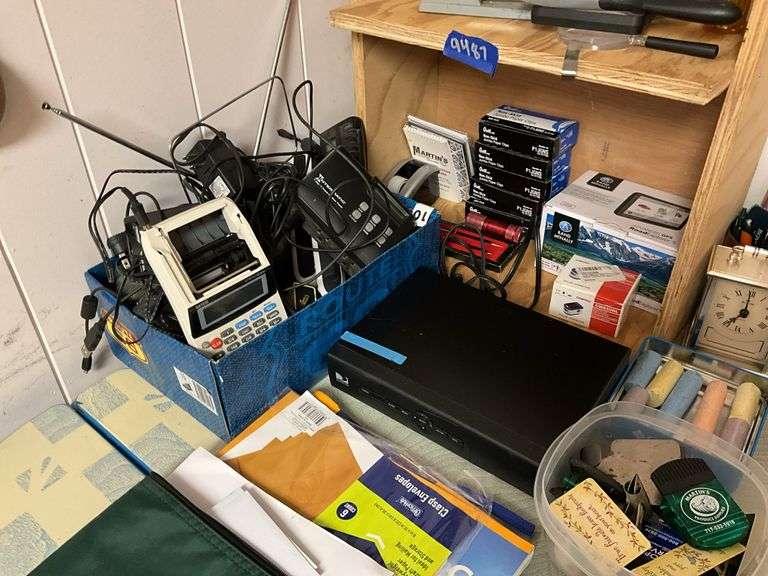Contents of table: shelf unit, office supplies, matches, calculator ...