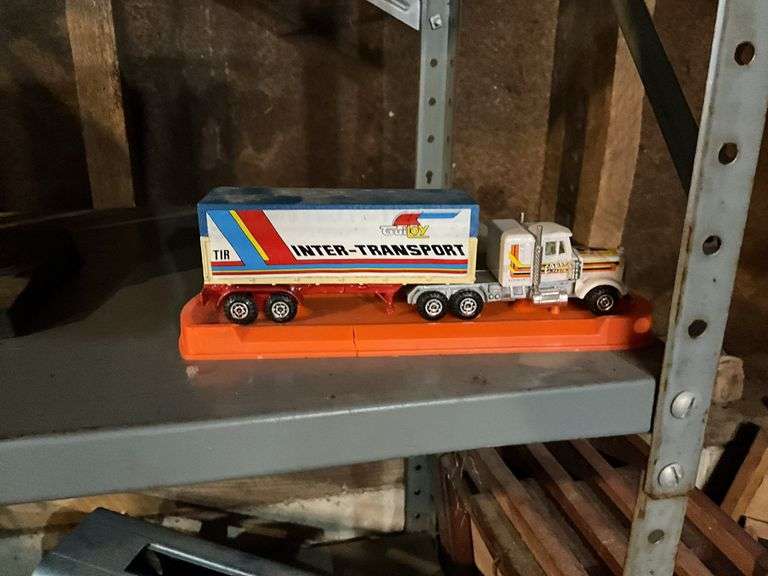 Contents of shelf: RC tractor trailer, Ford pickup model truck, model ...