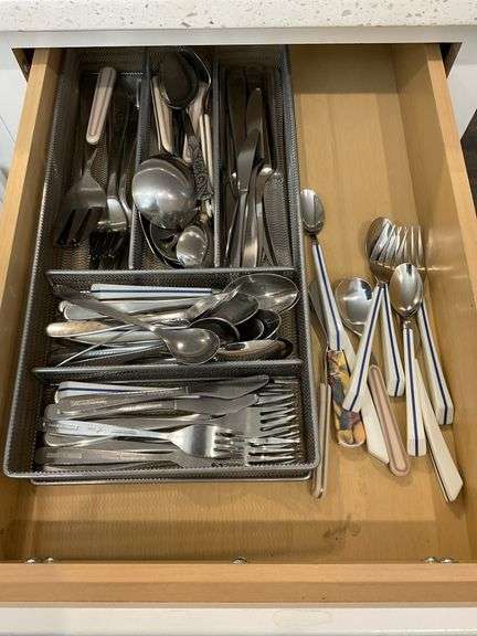 Contents of kitchen drawer - stainless still flatware & serving pieces ...