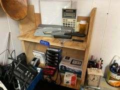 Contents of table: shelf unit, office supplies, matches, calculator ...