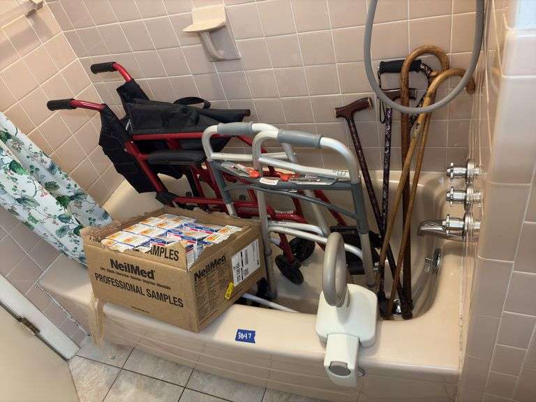 Ironing board and contents of bathtub: transport chair, walkers, canes ...