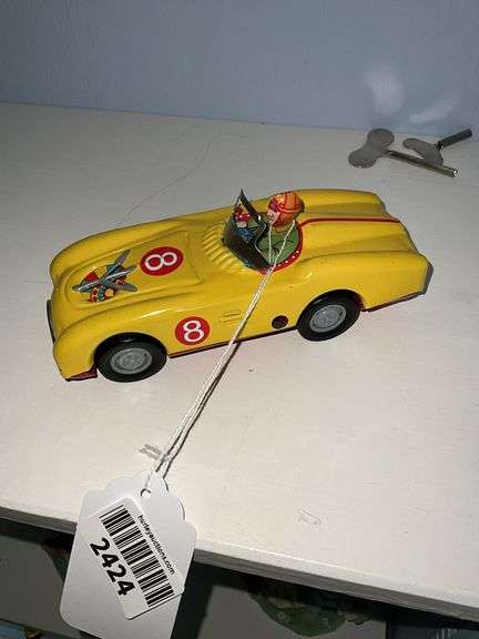 Litho tin toy wind-up race car w/ driver - Hurley Real Estate & Auctions