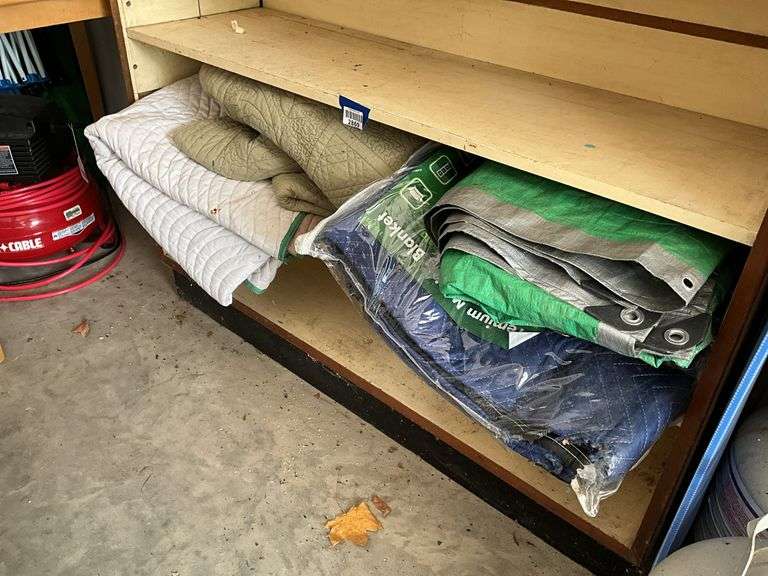 Contents of shelf: packing blankets, tarp - Hurley Real Estate & Auctions