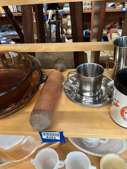 Contents of shelf: Baltimore Oriole mug, wooden stomper, metal cups ...