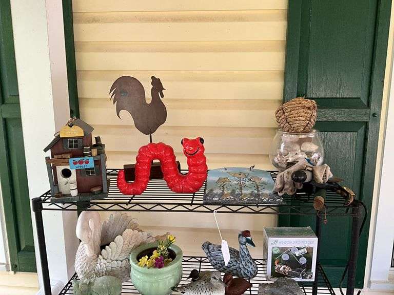 Contents of shelf: garden tools, decorative birdhouse, ceramic inch ...