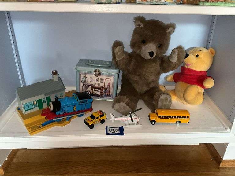 Contents of shelf: Pooh and Teddy bears, Thomas the Train, toy vehicles ...