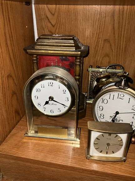 Contents of shelf: desk clocks, anniversary clock, alarm clocks, wall ...